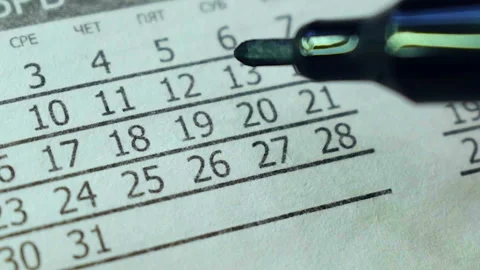 The girl marks the date in the calendar. | Stock Video | Pond5