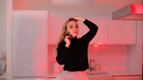 Girl, model sitting on the table takes o... | Stock Video | Pond5
