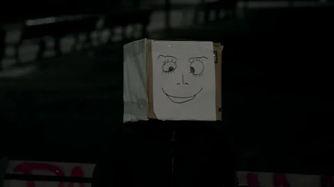 Girl at night wearing a box with a smile... | Stock Video | Pond5