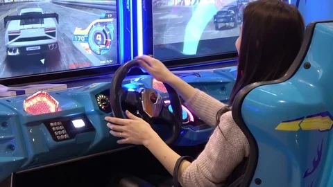 Girl playing auto simulator video arcade... | Stock Video | Pond5