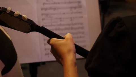 Girl is playing a balalaika, rear view. ... | Stock Video | Pond5