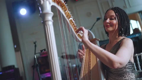 A girl plays a harp, a performance of a ... | Stock Video | Pond5