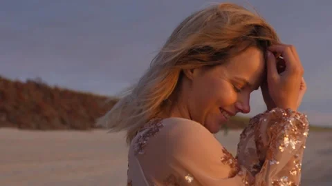 Girl pose shy in beach on sunset, handhe... | Stock Video | Pond5