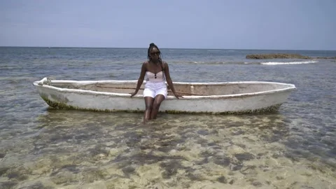 Girl Posing On A Small Boat Dipping In H... | Stock Video | Pond5