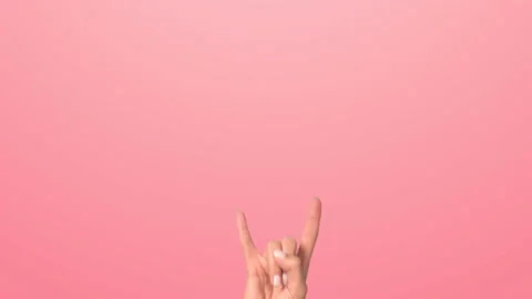 The girl raises a hand, showing rock. Cl... | Stock Video | Pond5