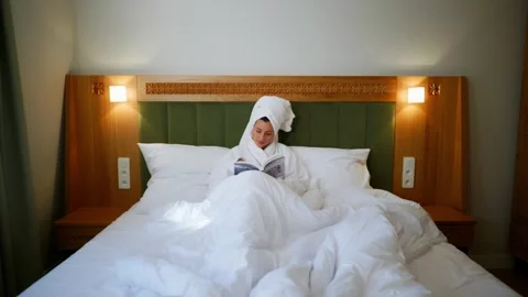 a girl reading a book. Girl after shower... | Stock Video | Pond5