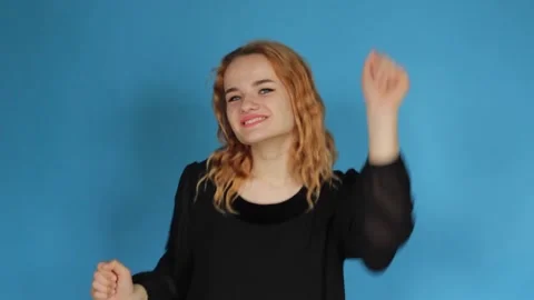 a girl with red hair dancing on a blue b... | Stock Video | Pond5