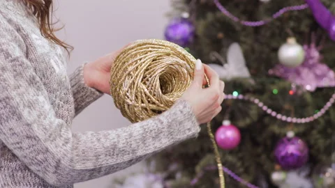 Girl reel a ball of golden thread | Stock Video | Pond5