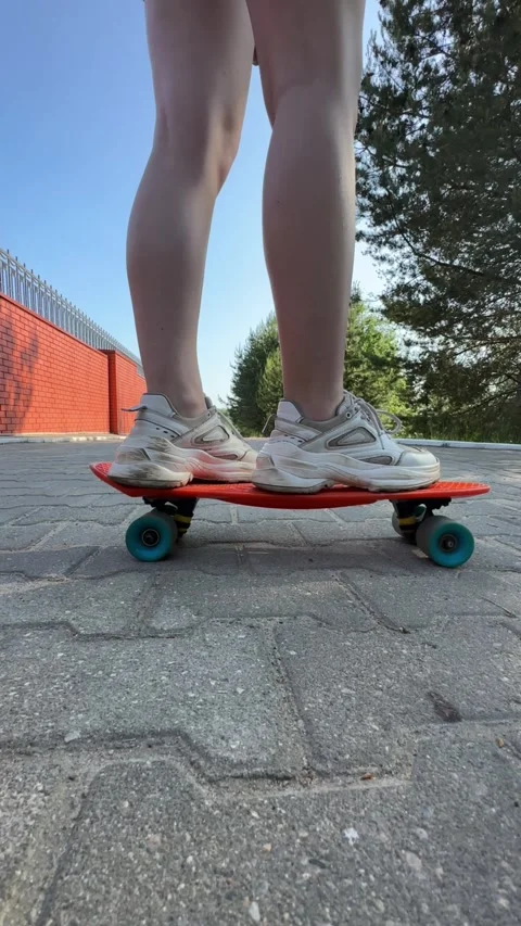 a girl rides an orange penny board. The ... | Stock Video | Pond5