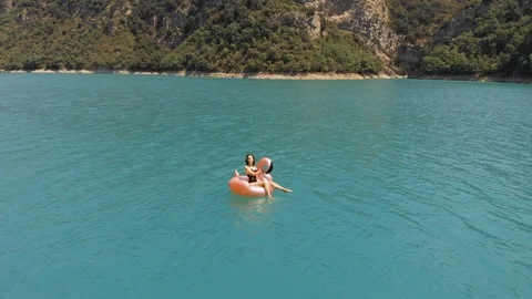 Girl riding the flamingo inflatable circ... | Stock Video | Pond5