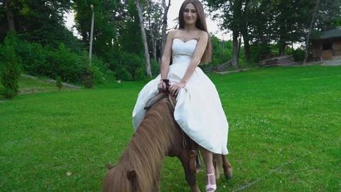 the girl is riding a pony | Stock Video | Pond5