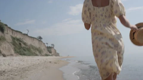 Girl running wet shore in slow motion ba... | Stock Video | Pond5