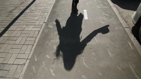 A girl runs along an asphalt road. The s... | Stock Video | Pond5