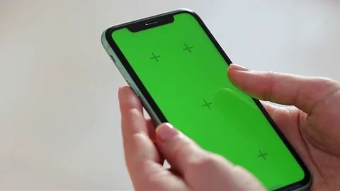 Girl scrolling phone green screen browsi... | Stock Video | Pond5