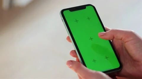 Girl scrolling phone green screen browsi... | Stock Video | Pond5