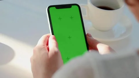 Girl scrolling phone green screen browsi... | Stock Video | Pond5