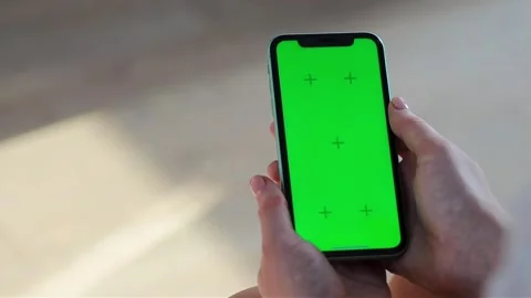 Girl scrolling phone green screen browsi... | Stock Video | Pond5