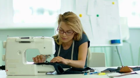 Girl is sewing a cloth on a sewing machi... | Stock Video | Pond5