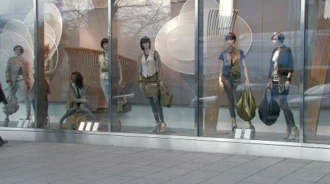 Girl by the shop window display | Stock Video | Pond5