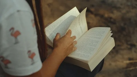 A girl sits in the forest reading a book... | Stock Video | Pond5