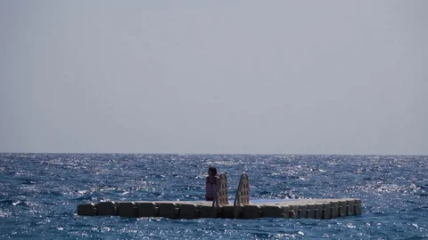 Girl sits on a raft in the middle of the... | Stock Video | Pond5