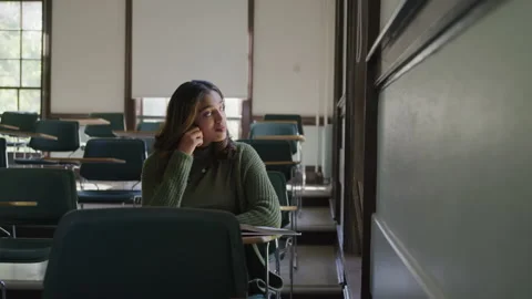 A Girl Sitting Alone in a Classroom Look... | Stock Video | Pond5