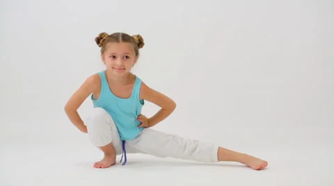 A girl sitting on one leg and make gymna... | Stock Video | Pond5