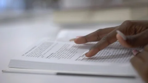 Girl skimming through book at library wi... | Stock Video | Pond5