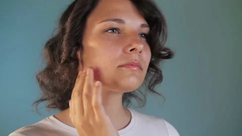 girl smears cream on her face standing o... | Stock Video | Pond5