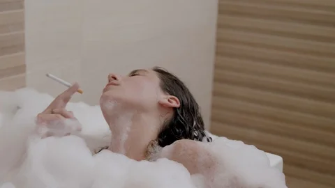 girl smoking a cigarette in a bubble bat... | Stock Video | Pond5