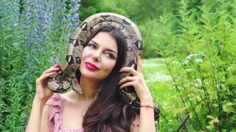 The girl with a snake around his neck . ... | Stock Video | Pond5
