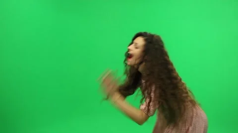 Girl spinning around on the green screen | Stock Video | Pond5