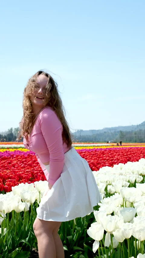girl is spinning in field with tulips wi... | Stock Video | Pond5