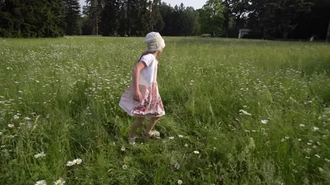 girl spinning in the middle of a field w... | Stock Video | Pond5