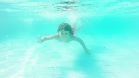 girl swimming underwater while diving | Stock Video | Pond5