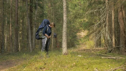 Girl takes off backpack in the forest | Stock Video | Pond5