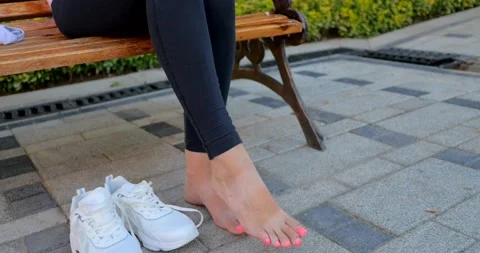 Girl takes off her sneakers and socks an... | Stock Video | Pond5