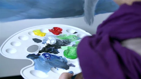 Girl taking color from palette in slow m... | Stock Video | Pond5