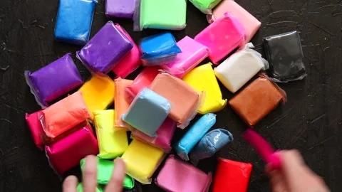 the girl unpacks light plasticine for mo... | Stock Video | Pond5