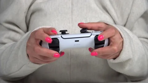 Girl uses dualsense controller to play v... | Stock Video | Pond5