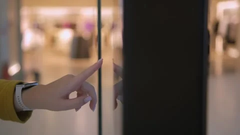 Girl using a touch terminal in a shoppin... | Stock Video | Pond5
