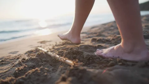 Girl walking barefoot on sand in Italy. | Stock Video | Pond5