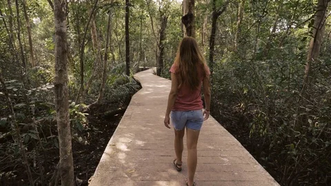 Girl walking in slow motion into the tro... | Stock Video | Pond5