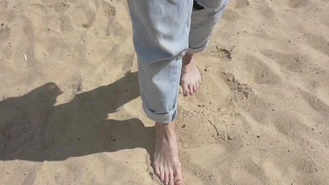 Girl walks barefoot on the sand by the s... | Stock Video | Pond5