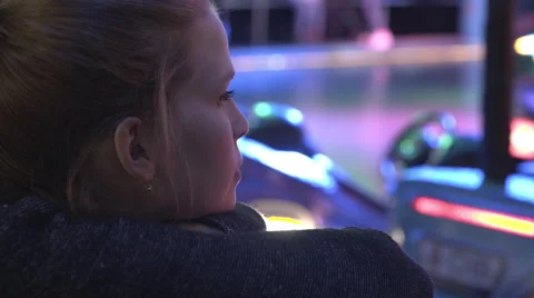Girl watching bumper cars at carnival 4k | Stock Video | Pond5