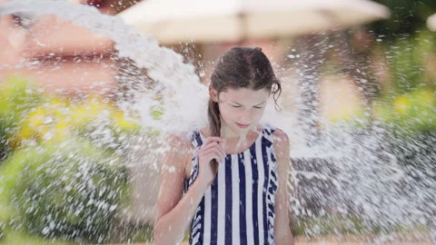 Girl In Waterpark Gets Splashed By Water | Stock Video | Pond5