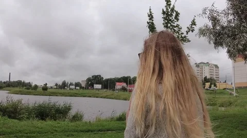 A girl is waving to the wind in bad weat... | Stock Video | Pond5