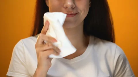 Girl wiping face with napkin after eatin... | Stock Video | Pond5