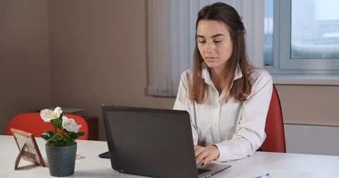 Girl work in office, types, pick up phot... | Stock Video | Pond5