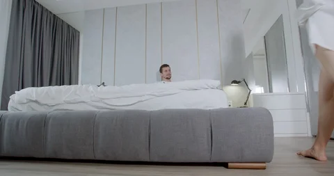 Girlfriend gets on the bed with her boyf... | Stock Video | Pond5